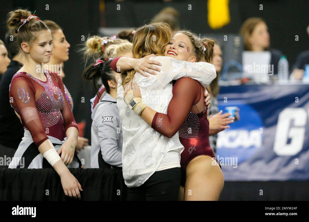 Oklahoma's Keeley Kmieciak hugs head coach K.J. Kindler, center, after ...