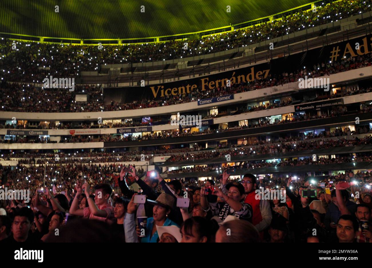 Spectators take pictures as Mexican singer Vicente Fernandez performs ...