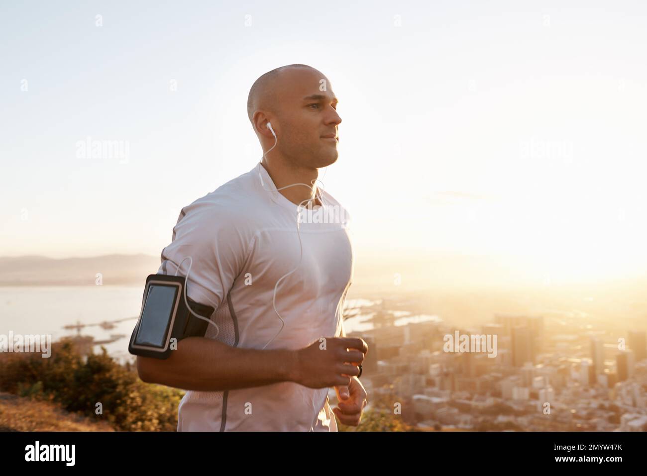 Getting into his run with some great music. a young man listening to ...