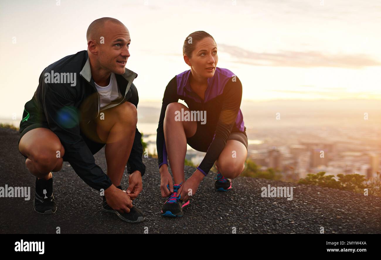 Couple tying shoelaces before hi-res stock photography and images - Alamy