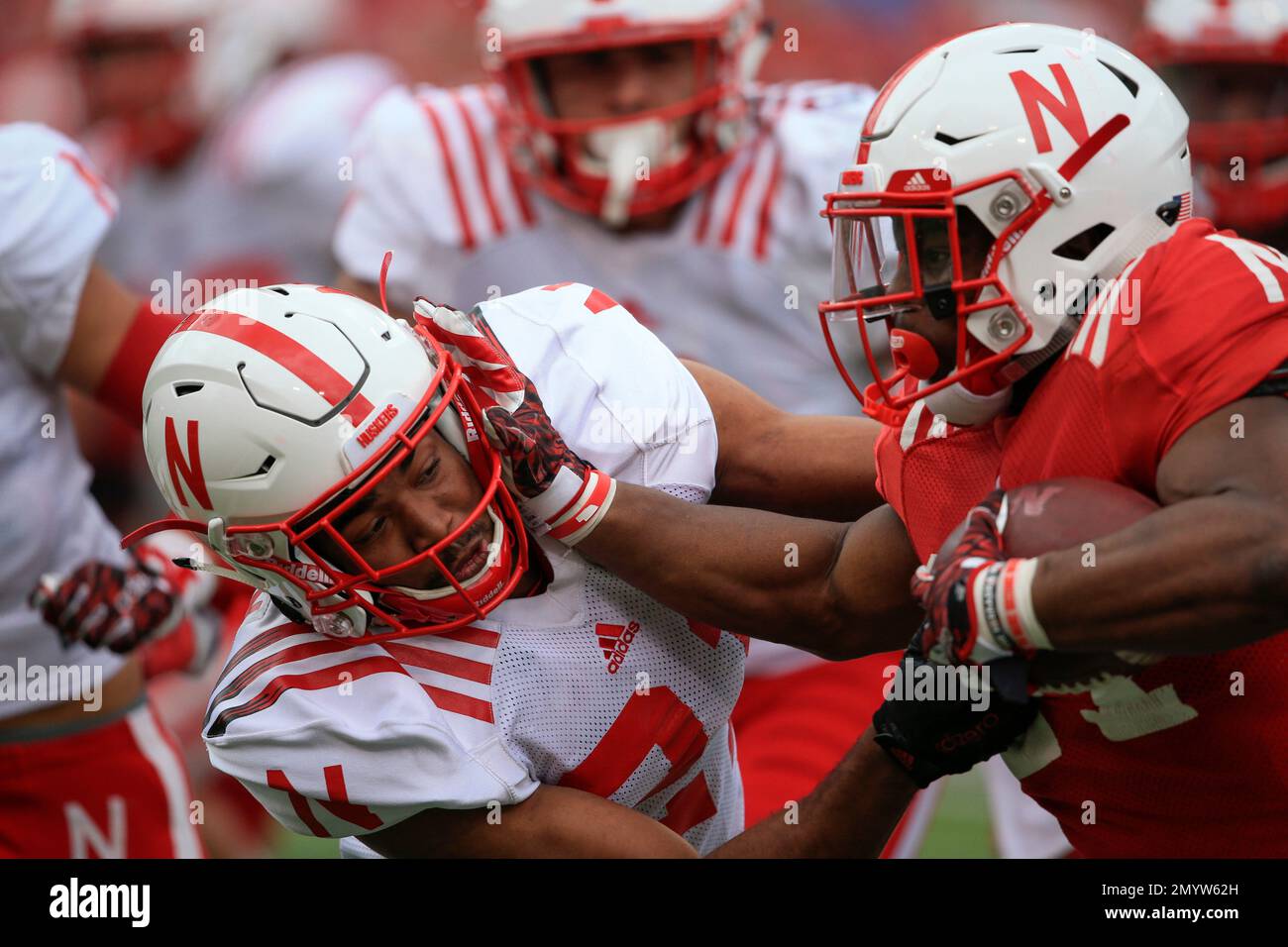 Nebraska red team running back Mikale Wilbon (21), right, is tackled by ...