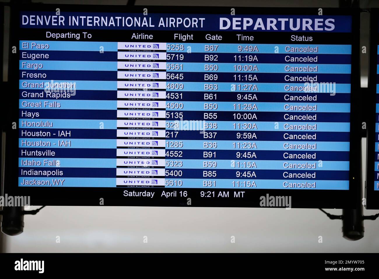 A flight board for departing United Airlines flights shows ...