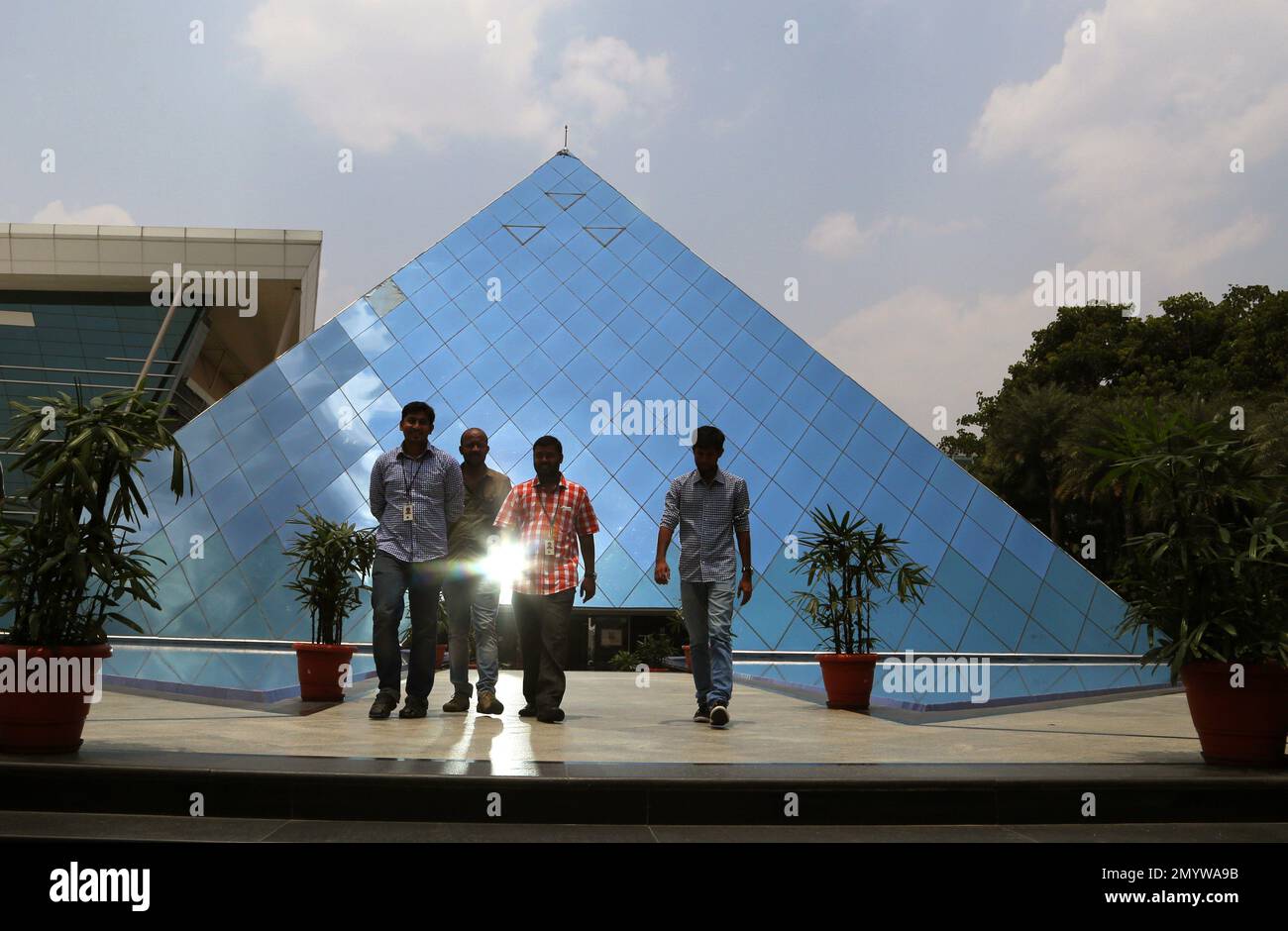 Infosys employees leave a pyramid shaped building at their company's ...