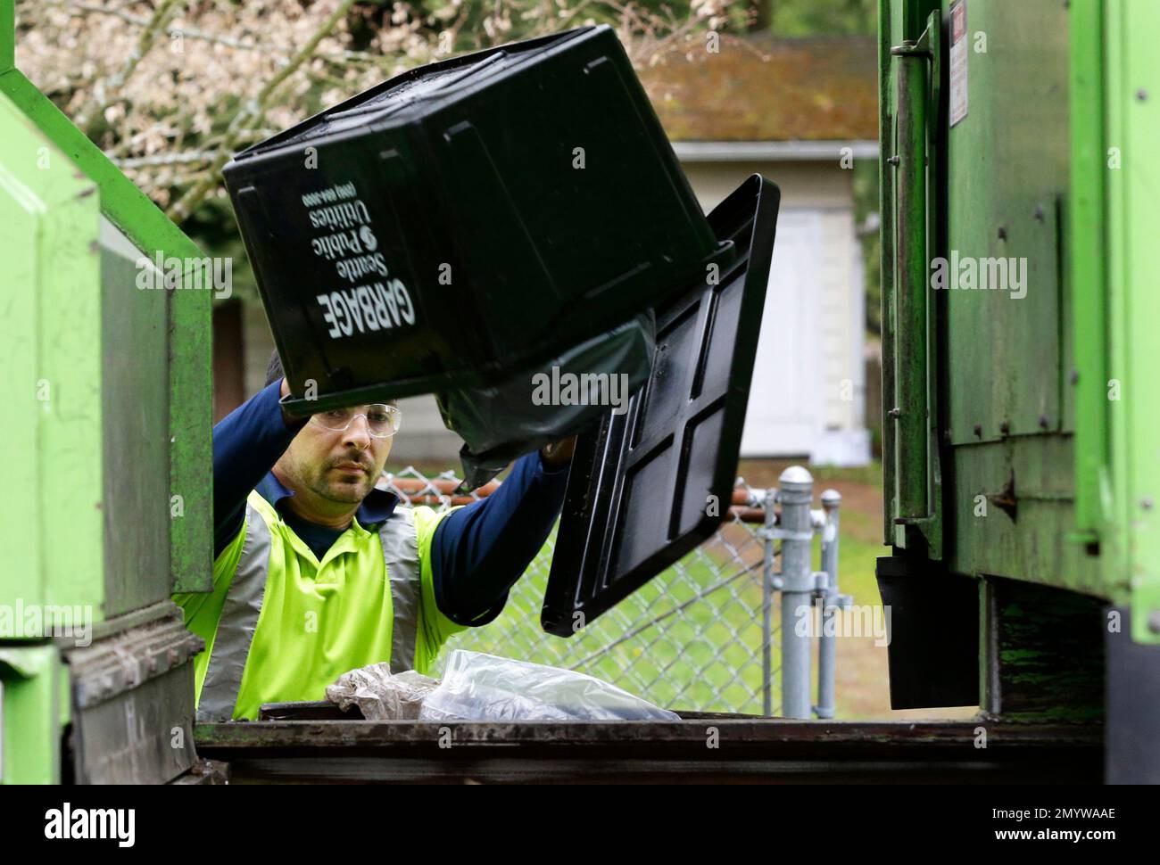 David Morales, a garbage driver with Recology, picks up a garbage ...