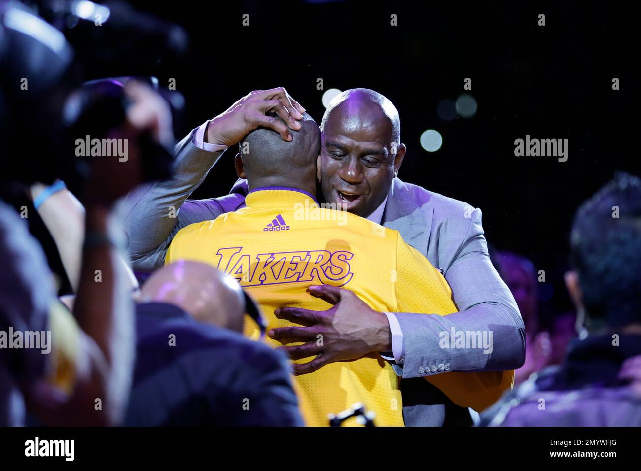 Los Angeles Lakers forward Kobe Bryant, left, hugs Magic Johnson during ...