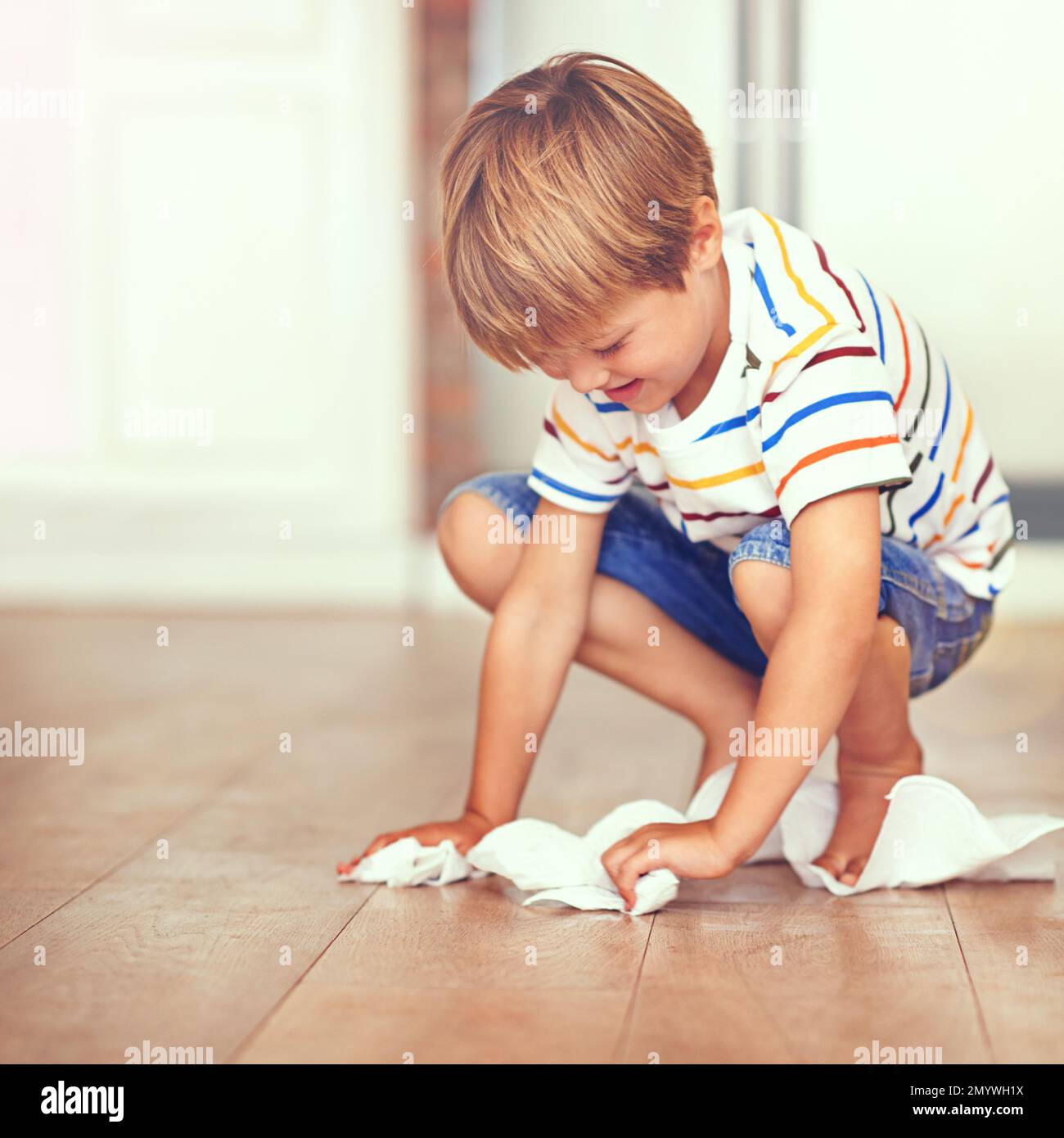 Ill clean this before mom sees...a little boy wiping the floor with ...