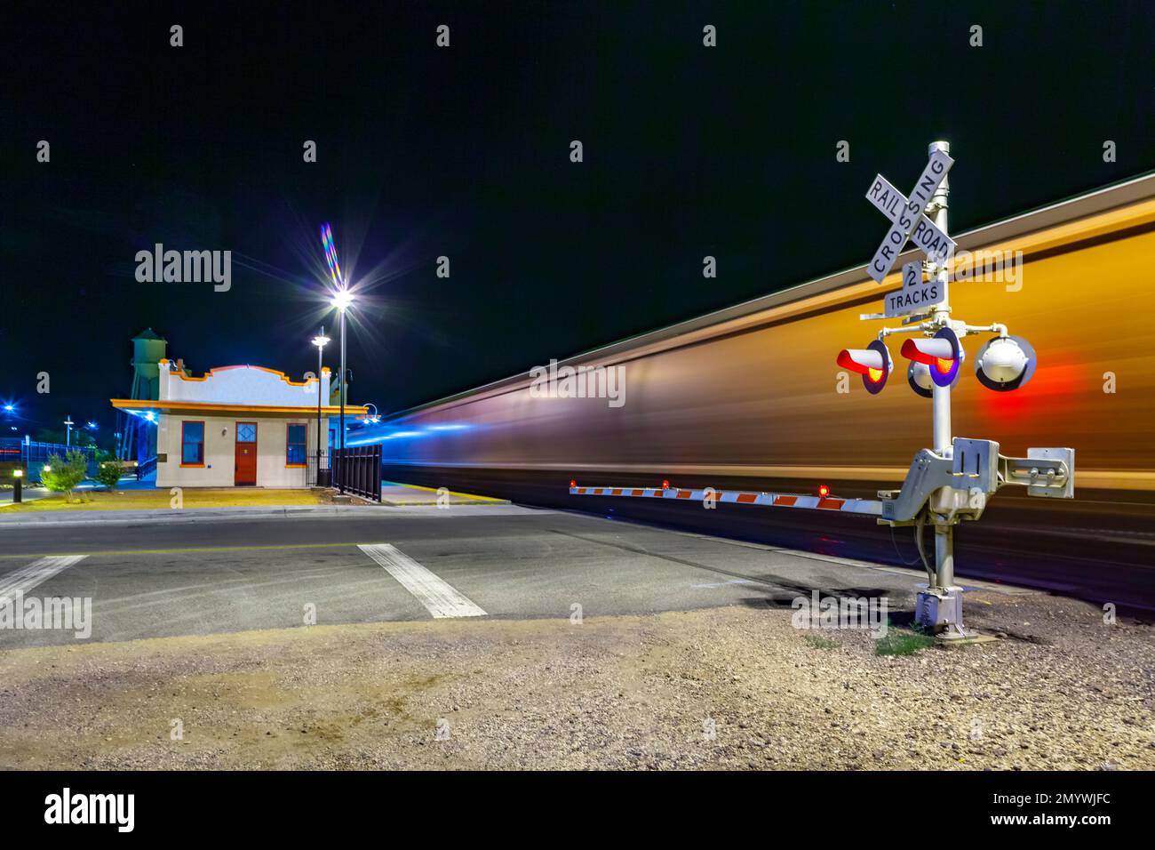 train passes at railroad crossing in the night. The Kingman station of ...
