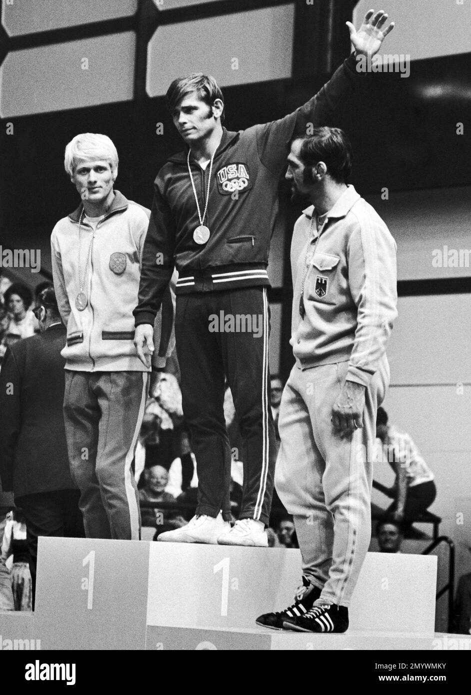 Wayne Wells, center, from the United States waves to the crowd after he ...
