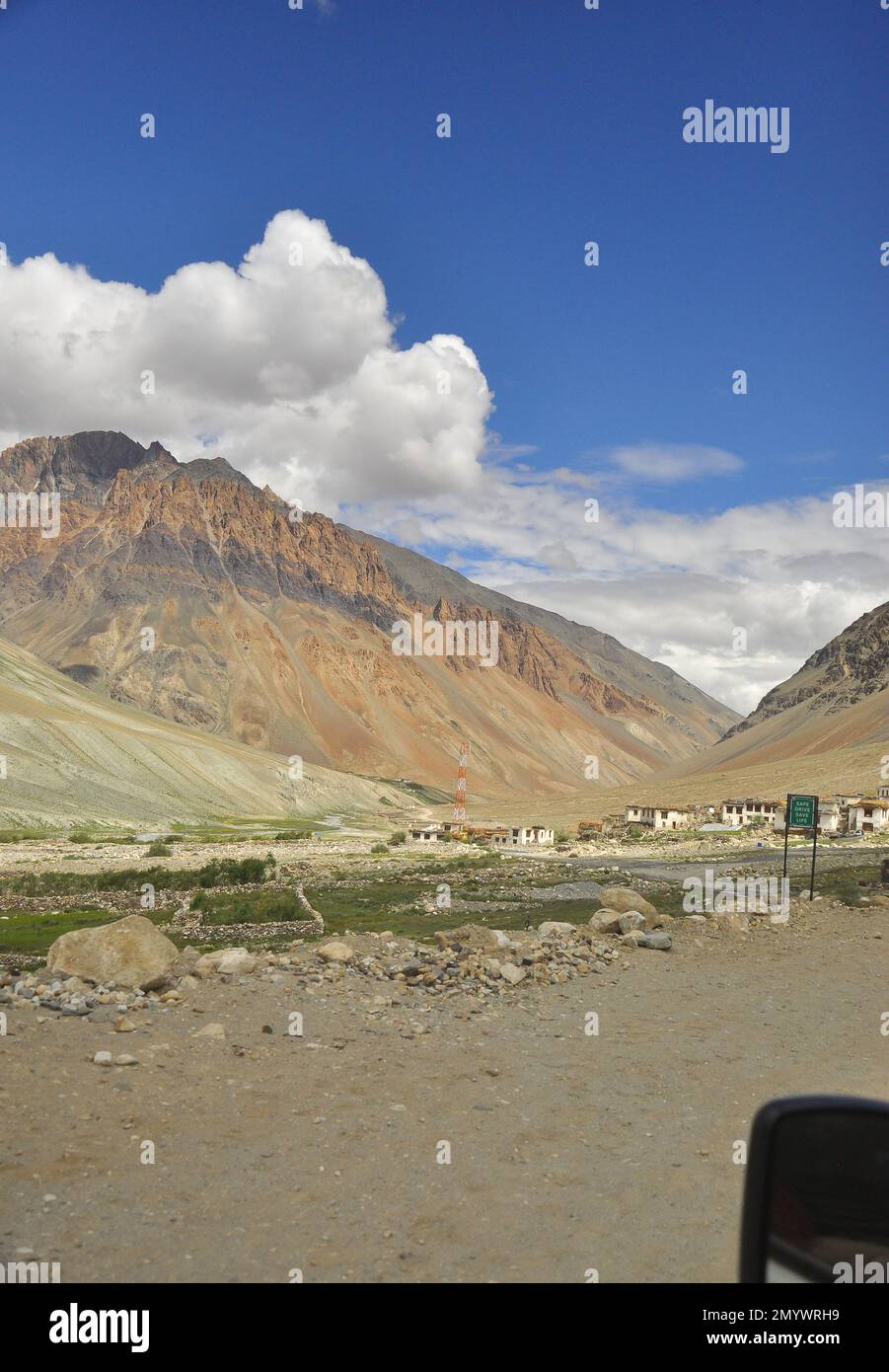 A beautiful view of village in between dry mountains view from car ...