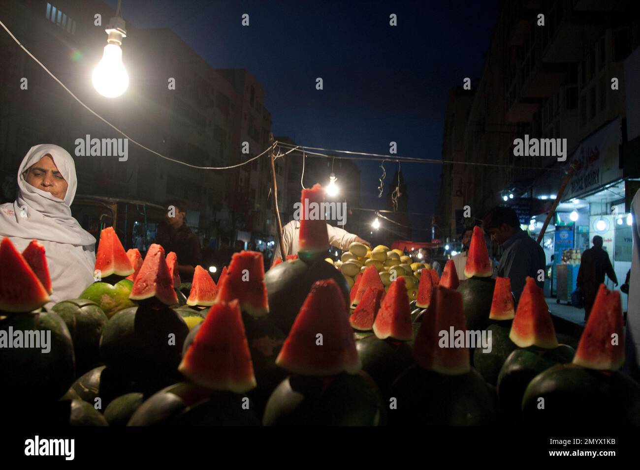 A Pakistani vendor sells watermelon slices in Karachi, Pakistan, Monday ...