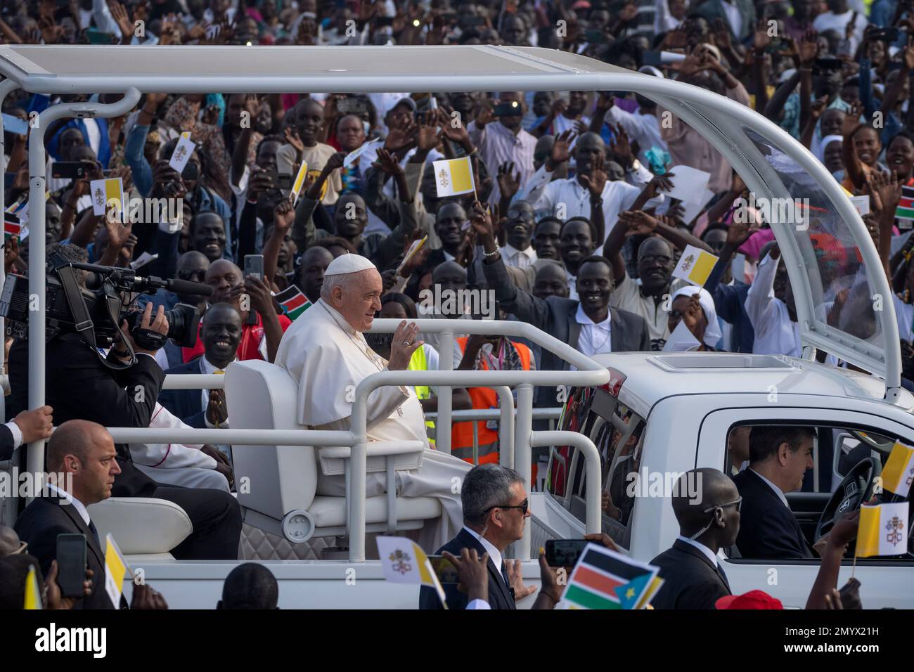 Pope Francis waves as he tours the audience in his vehicle after ...