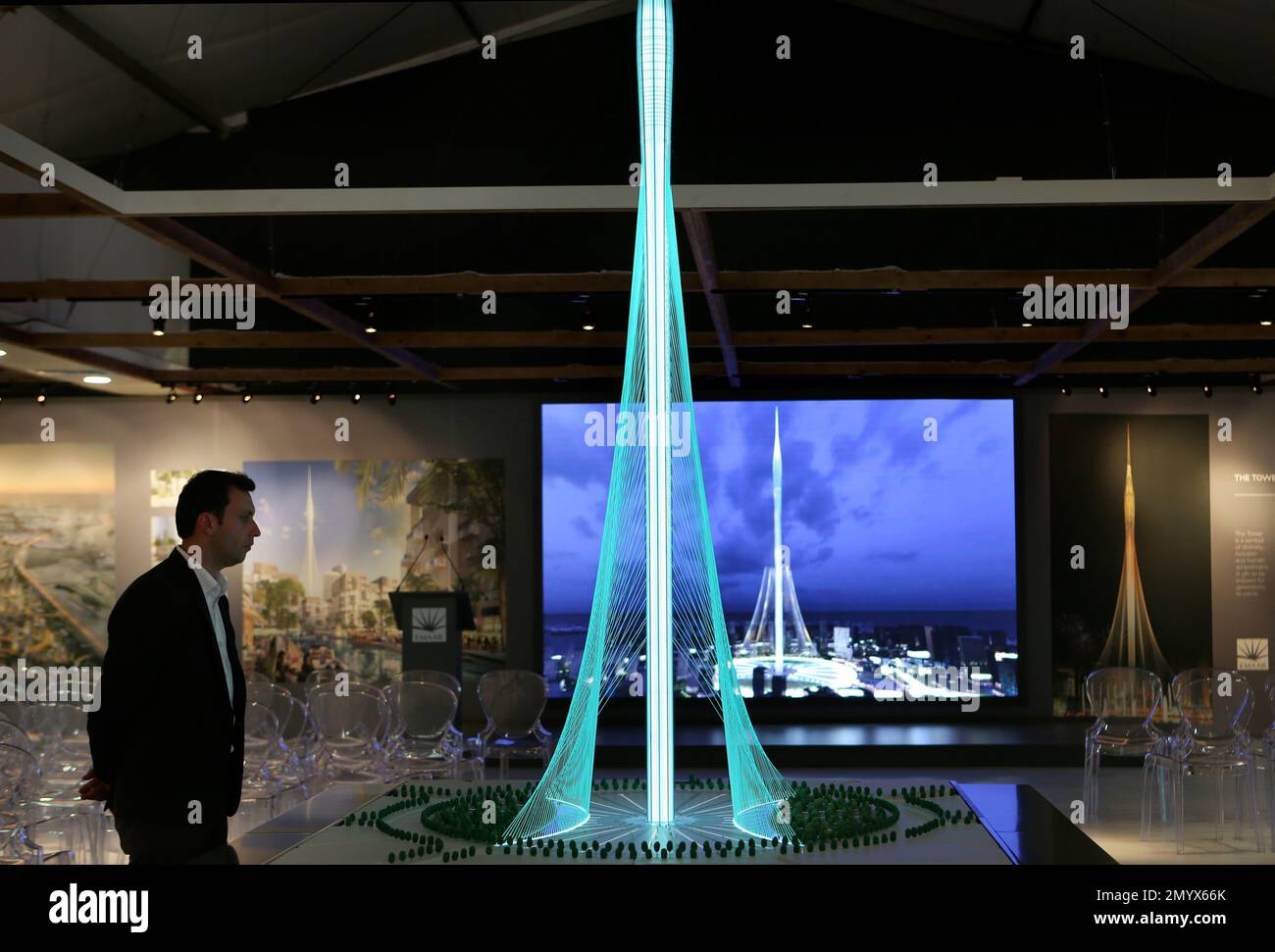 A man walks past a model of the Tower Project at Dubai Creek Harbour ...