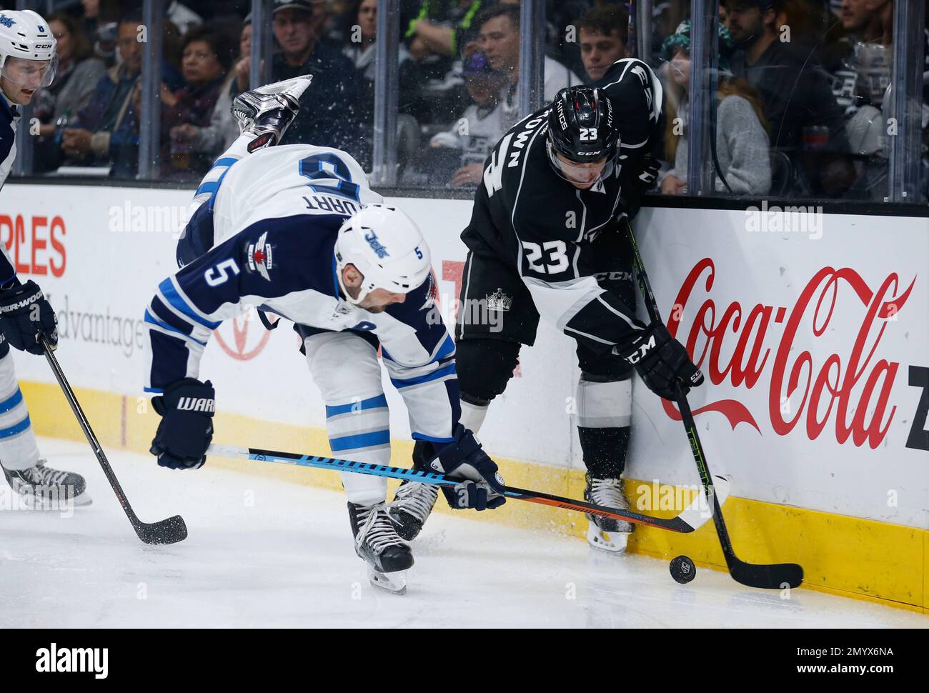Winnipeg Jets defenseman Mark Stuart, left, and Los Angeles Kings right ...