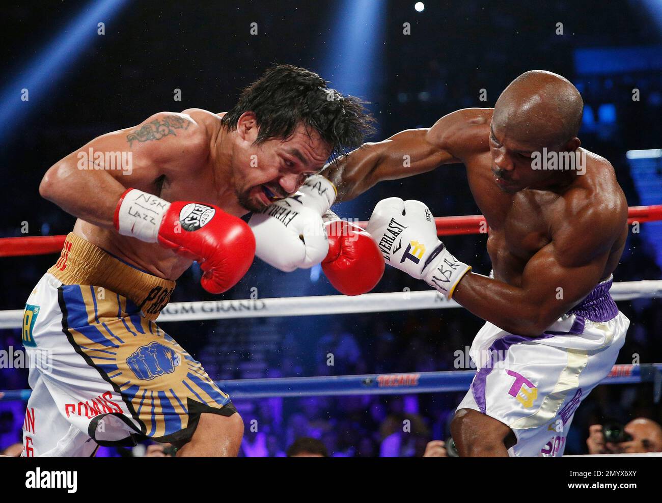 Timothy Bradley, right, punches Manny Pacquiao, of the Philippines ...