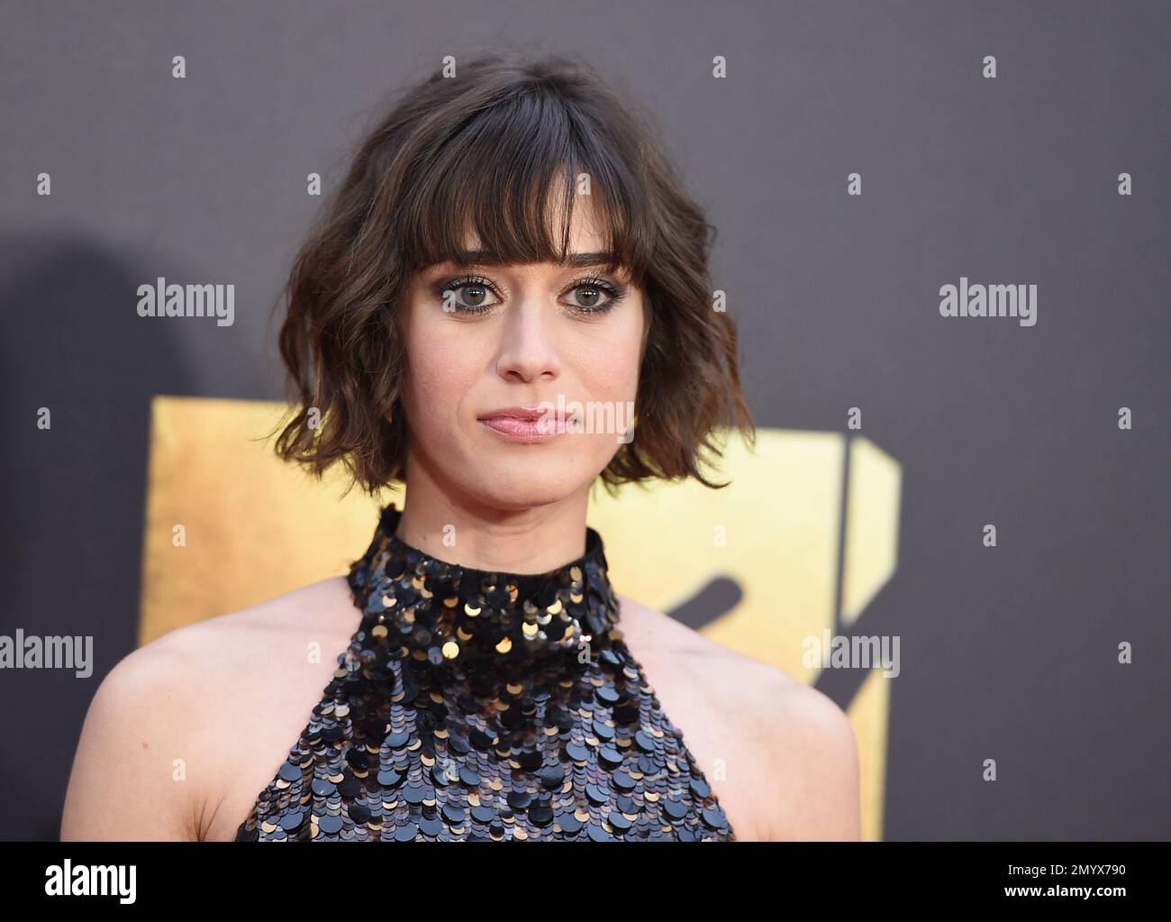 Lizzy Caplan arrives at the MTV Movie Awards at Warner Bros. Studios on ...