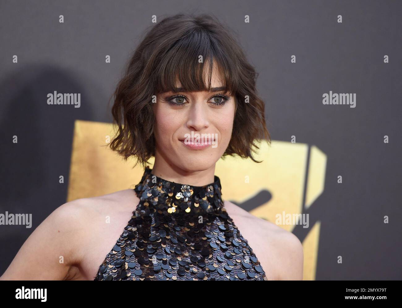 Lizzy Caplan arrives at the MTV Movie Awards at Warner Bros. Studios on ...