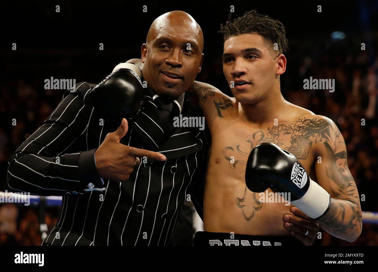 British boxing legend Nigel Benn, left, celebrates with his son Conor ...