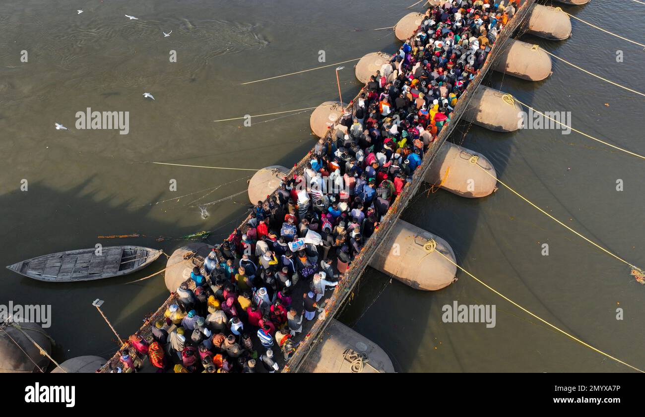 Hindu devotees cross a pontoon bridge at Sangam, the confluence of ...
