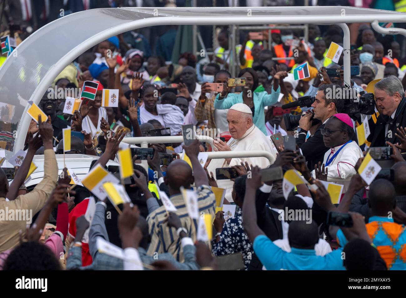 Pope Francis waves as he tours the audience in his vehicle after ...