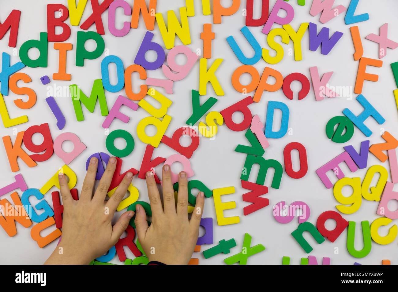 Young girl's hands sorting through Alphabet magnets on whiteboard Stock ...