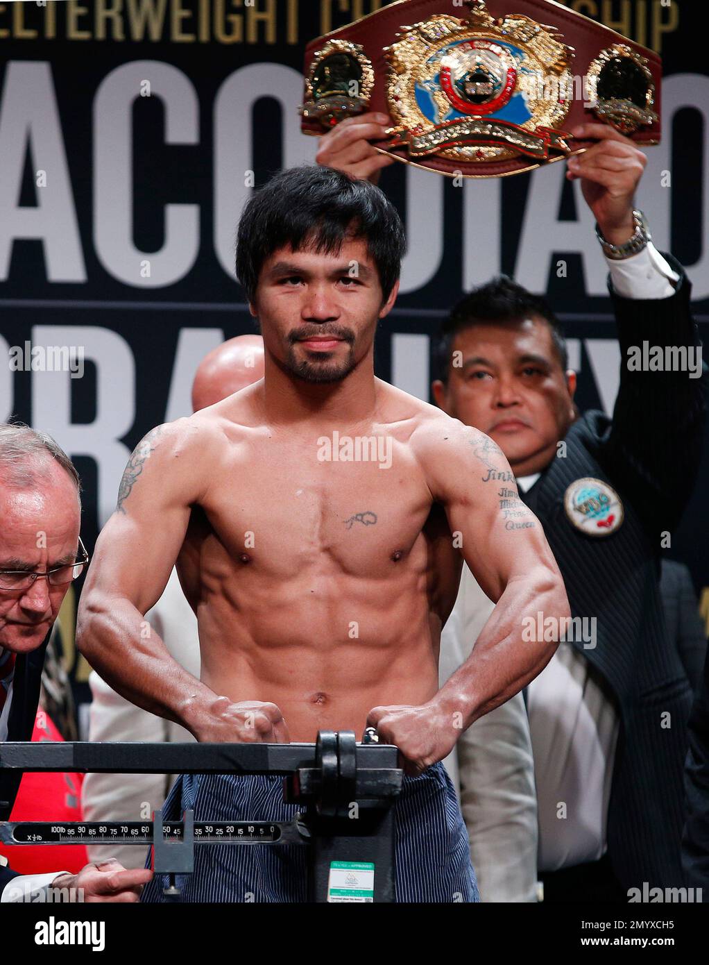 Manny Pacquiao, of the Philippines, poses on the scale during a weigh ...