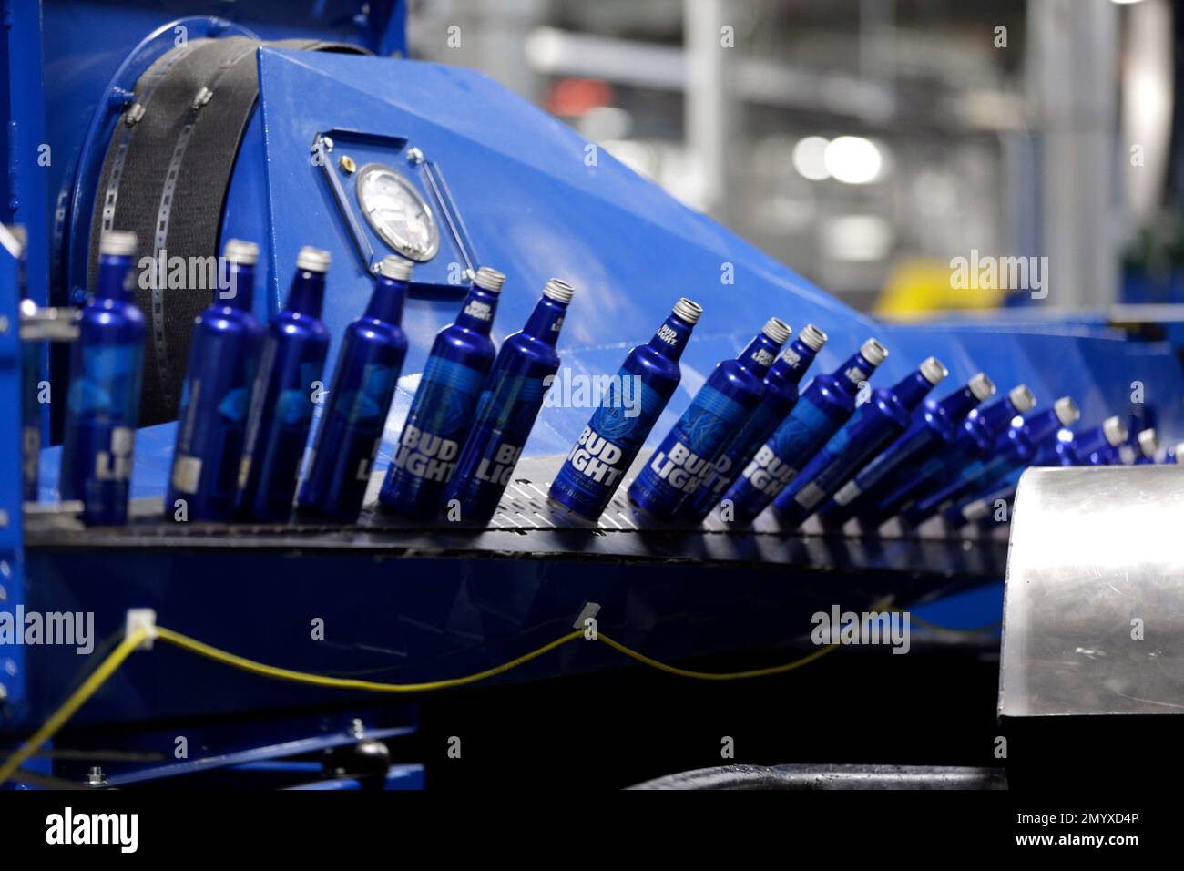 Aluminum Bud Light beer bottles move along a conveyor inside a newly ...