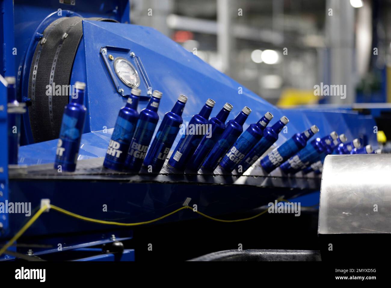 Aluminum Bud Light beer bottles move along a conveyor inside a newly ...