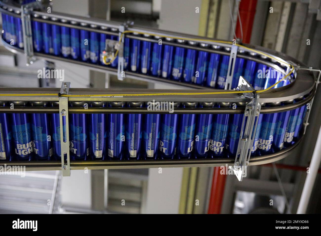 Aluminum Bud Light beer bottles move along a conveyor inside a newly ...