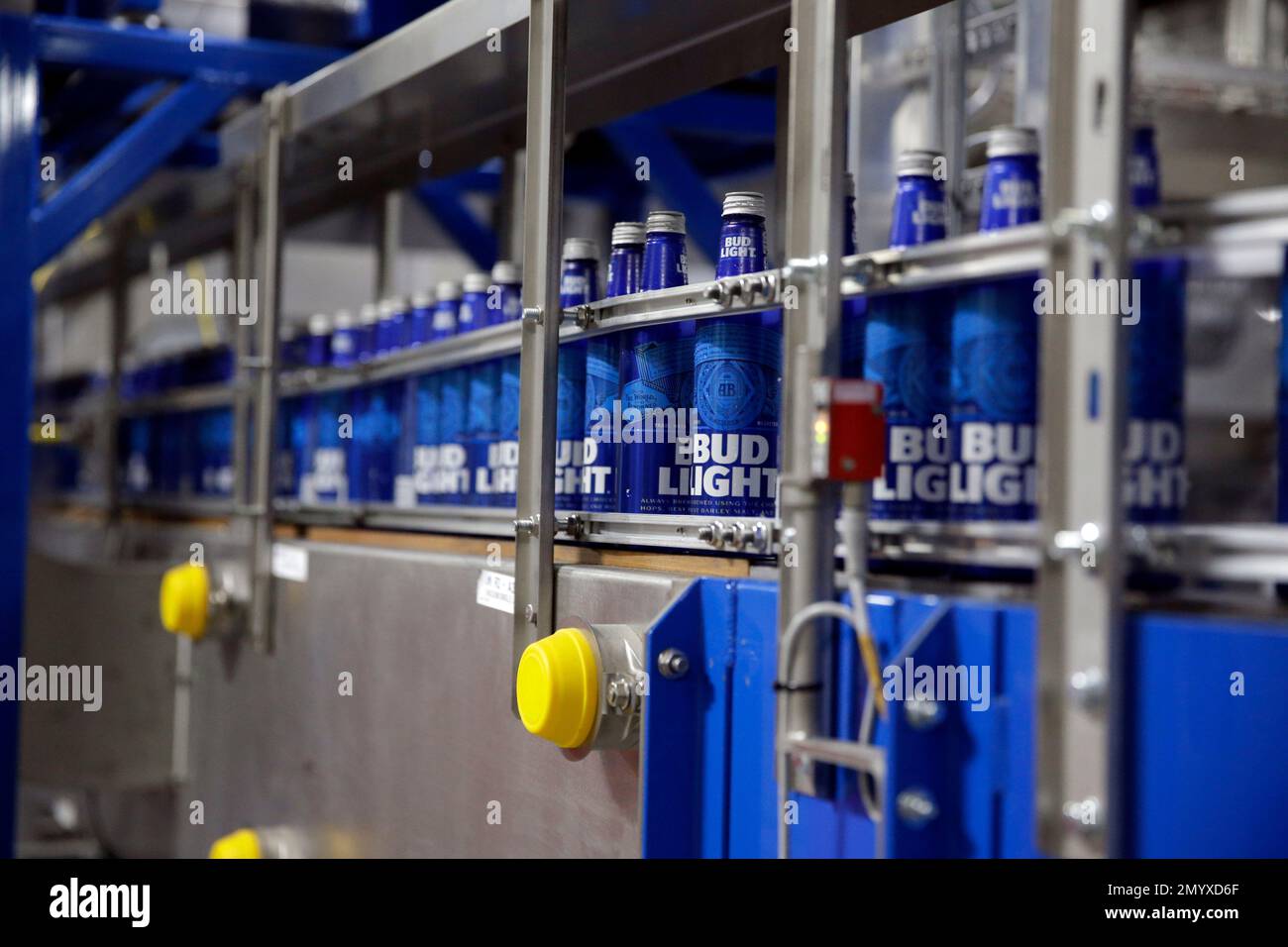 Aluminum Bud Light beer bottles move along a conveyor inside a newly ...