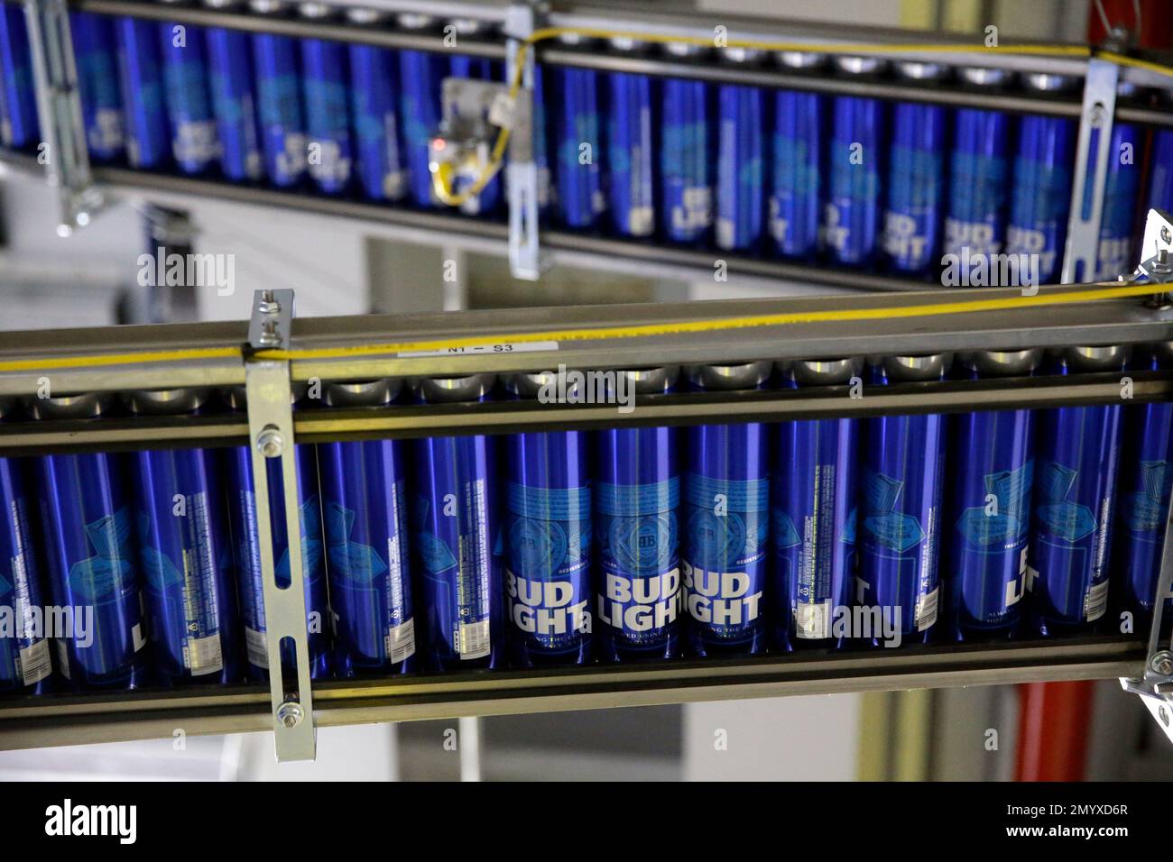 Aluminum Bud Light beer bottles move along a conveyor inside a newly ...