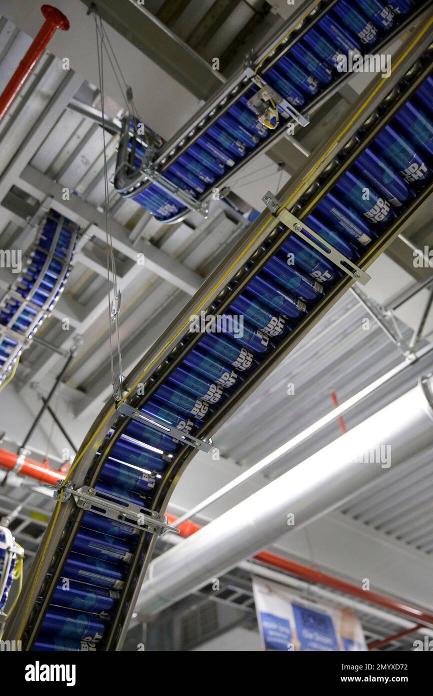Aluminum Bud Light beer bottles move along a conveyor inside a newly ...