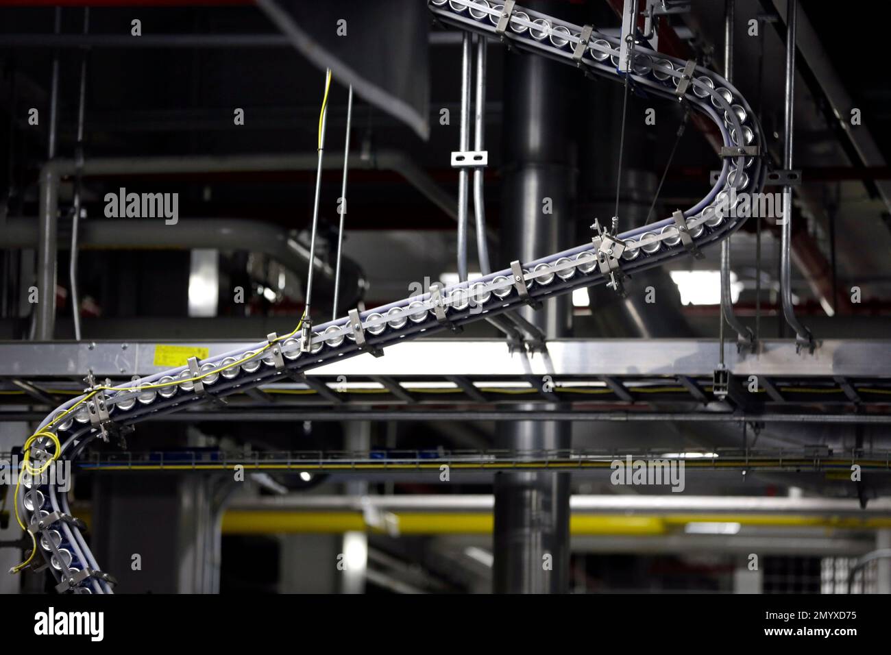 Aluminum Bud Light beer bottles move along a conveyor inside a newly ...