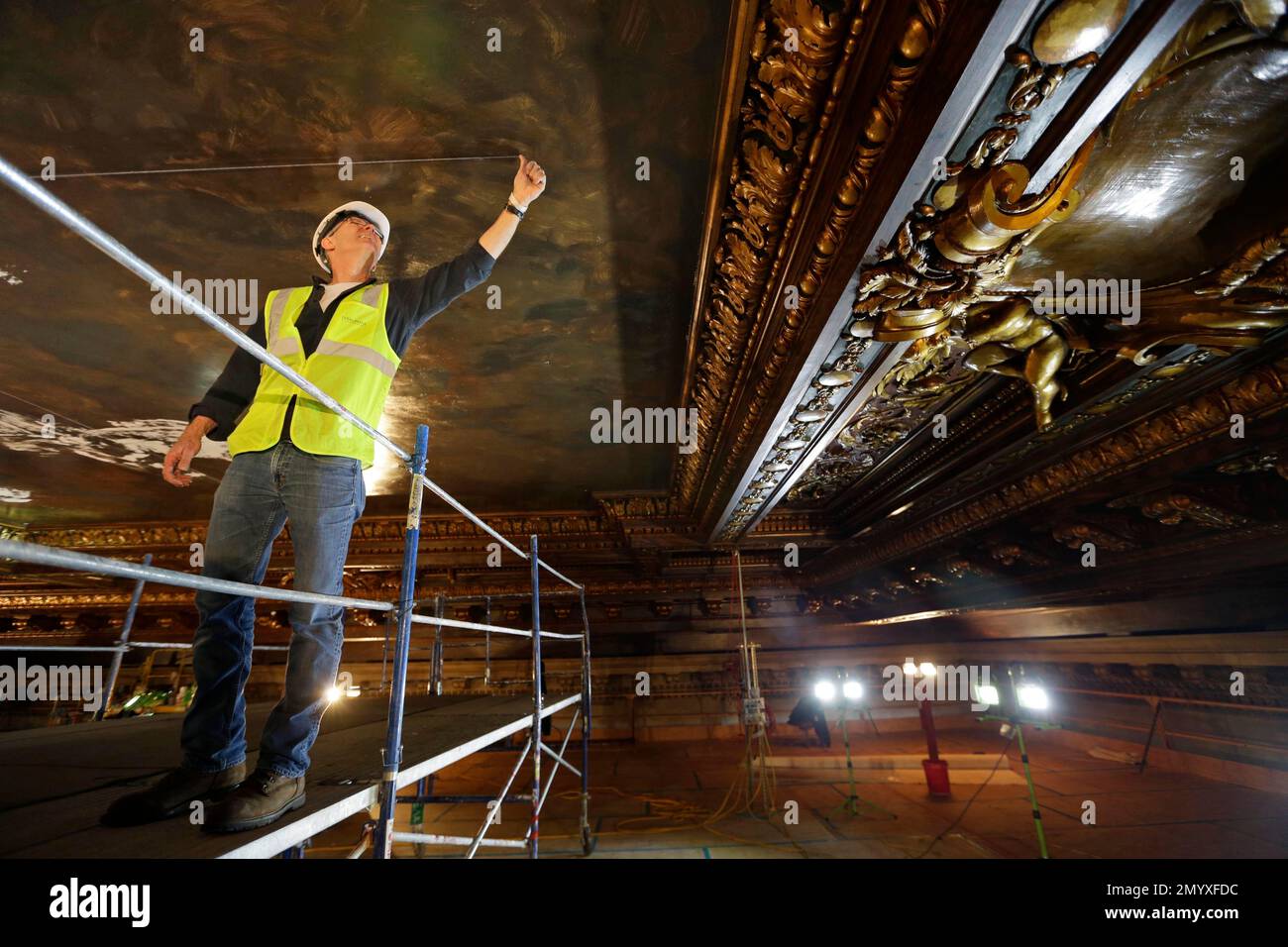 Mural director Bill Mensching helps prepare the ceiling for a new mural ...