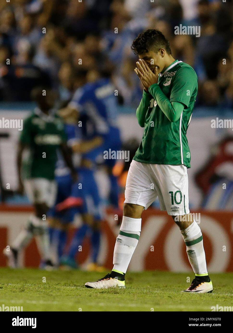 Andres Roa of Colombia's Deportivo Cali, right, covers his face after ...