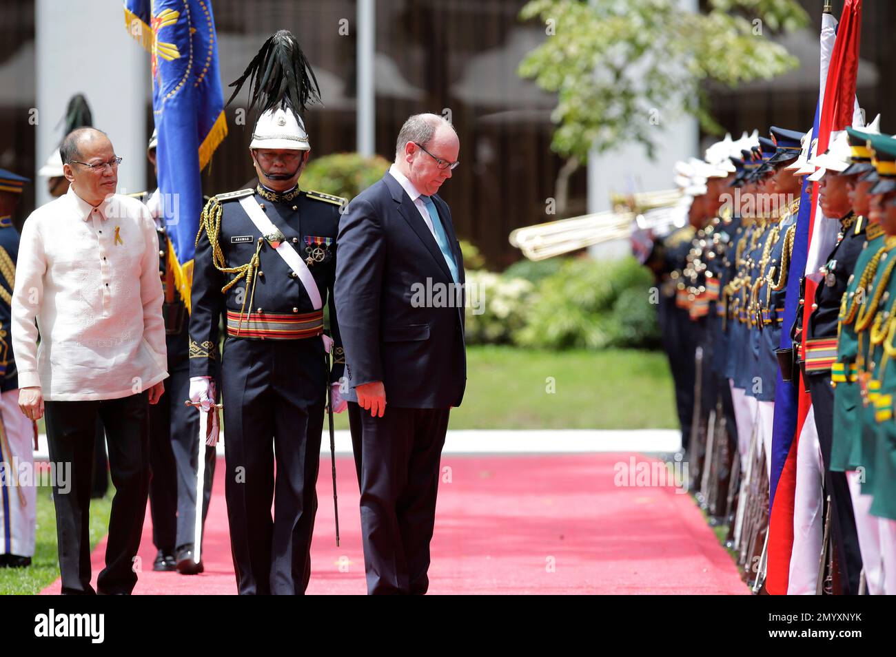Prince Albert II of Monaco, center, bows in respect to Philippine and ...