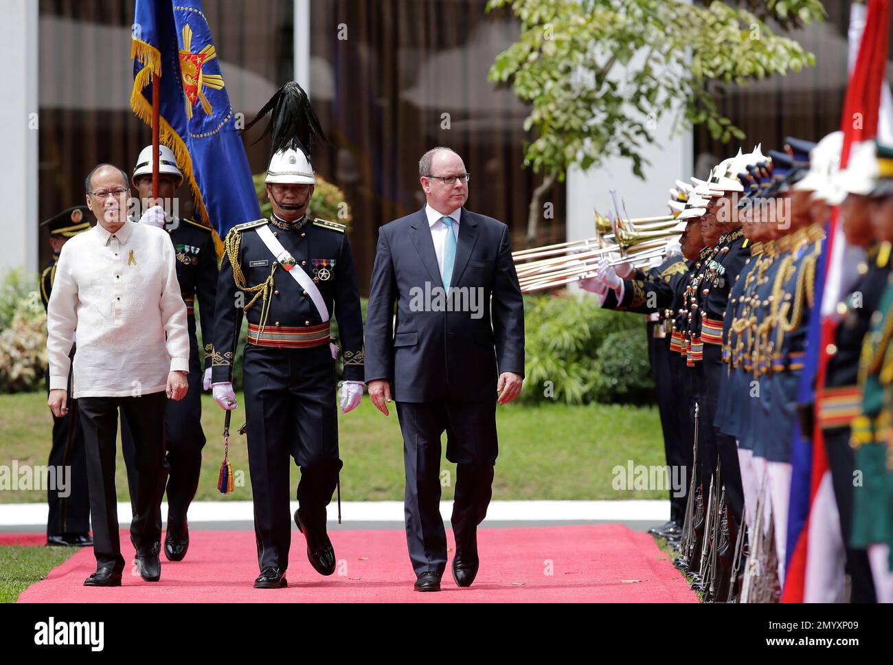 Prince Albert II of Monaco, center, walks with President Benigno Aquino ...