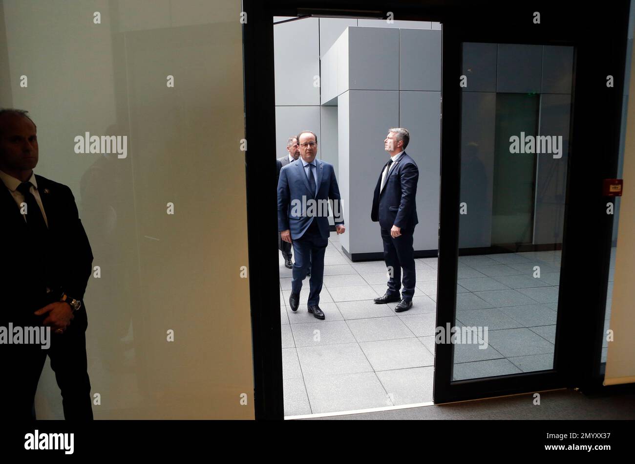 French President Francois Hollande, center left, walks in during a ...