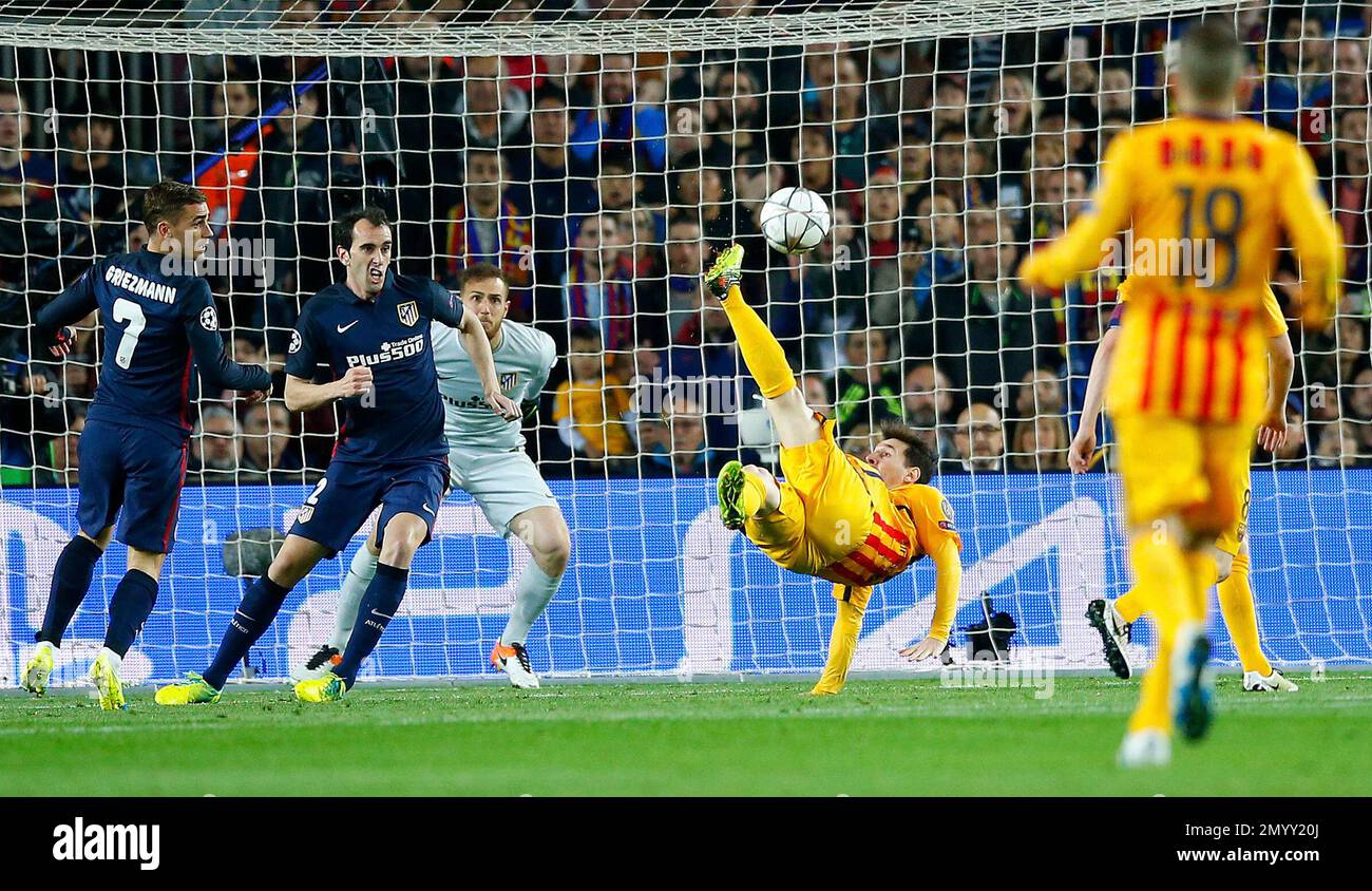 Barcelona's Lionel Messi, center right, shoots at goal with an overhead ...