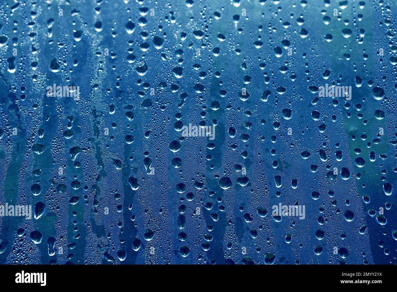 Blue texture of rain drops on the glass Stock Photo - Alamy