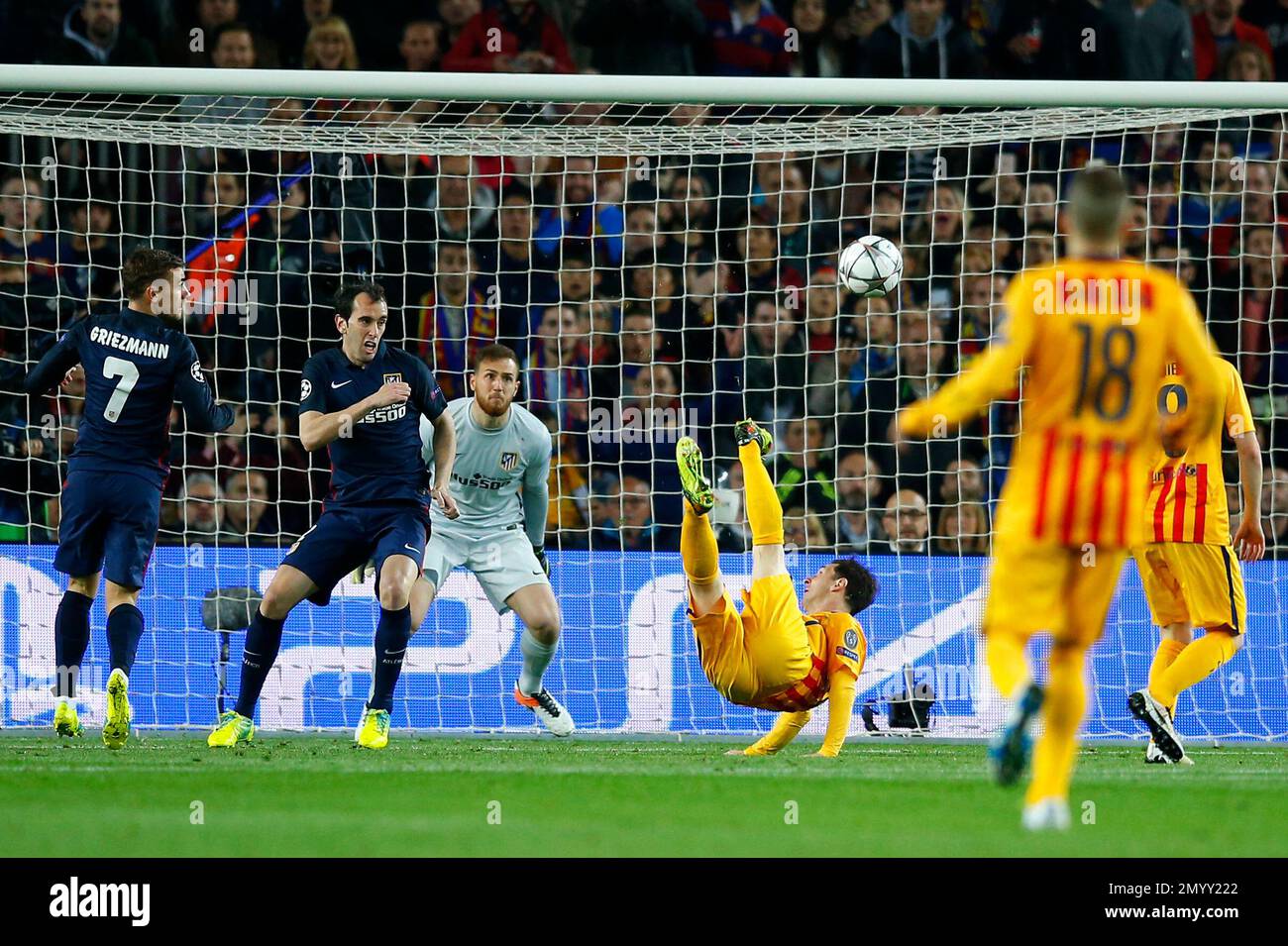 Barcelona's Lionel Messi, center right, shoots at goal with an overhead ...
