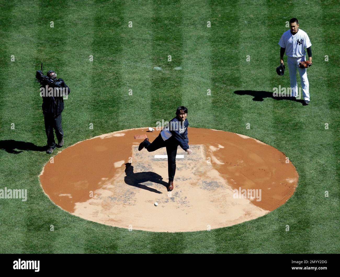 While New York Yankees starting pitcher Masahiro Tanaka, right, looks on, former New York Yankee ...