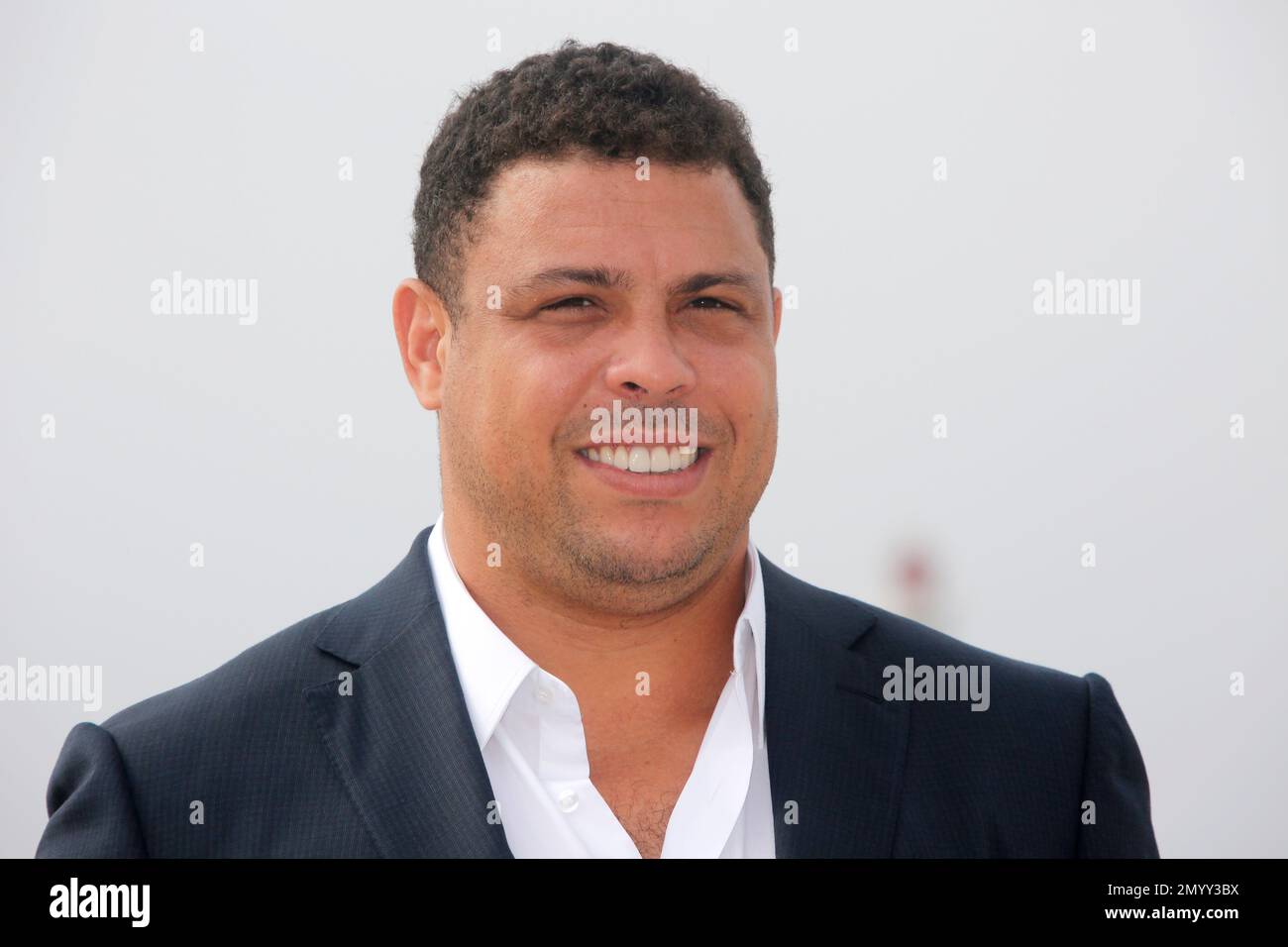 Retired Brazilian footballer Ronaldo poses for photographers during the ...