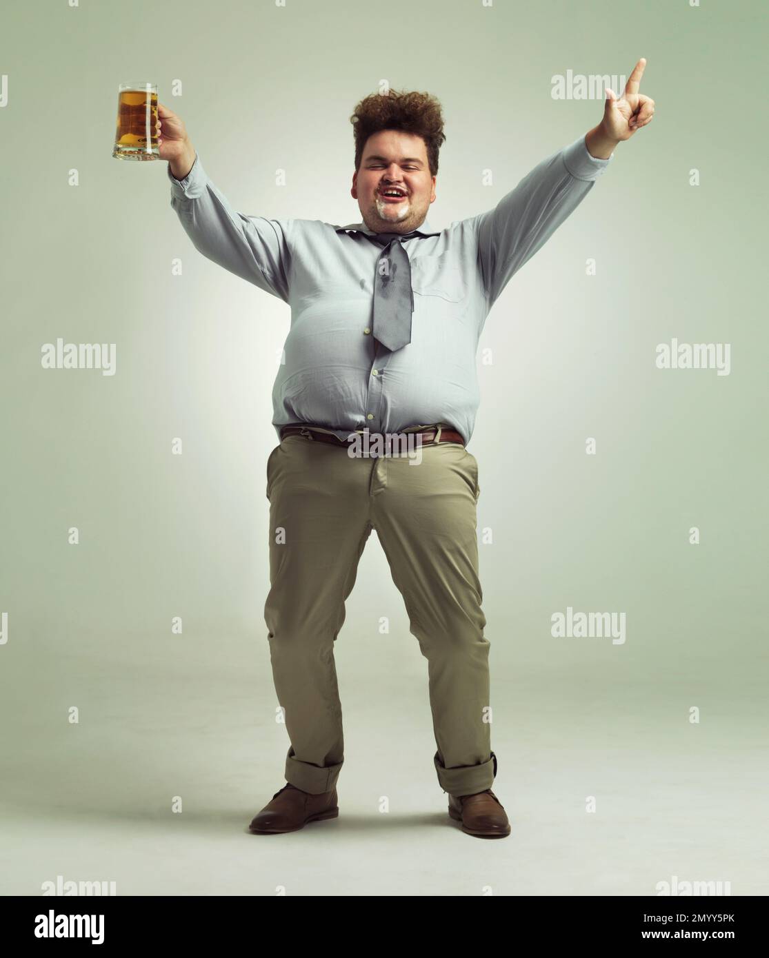 Time to party. an overweight man celebrating while holding a pint of ...