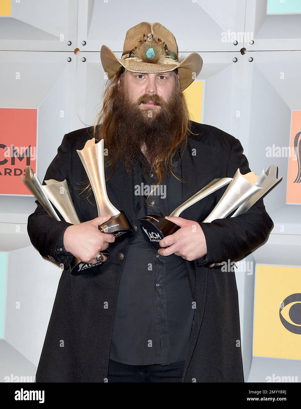Chris Stapleton poses in the press room with the awards for album of ...