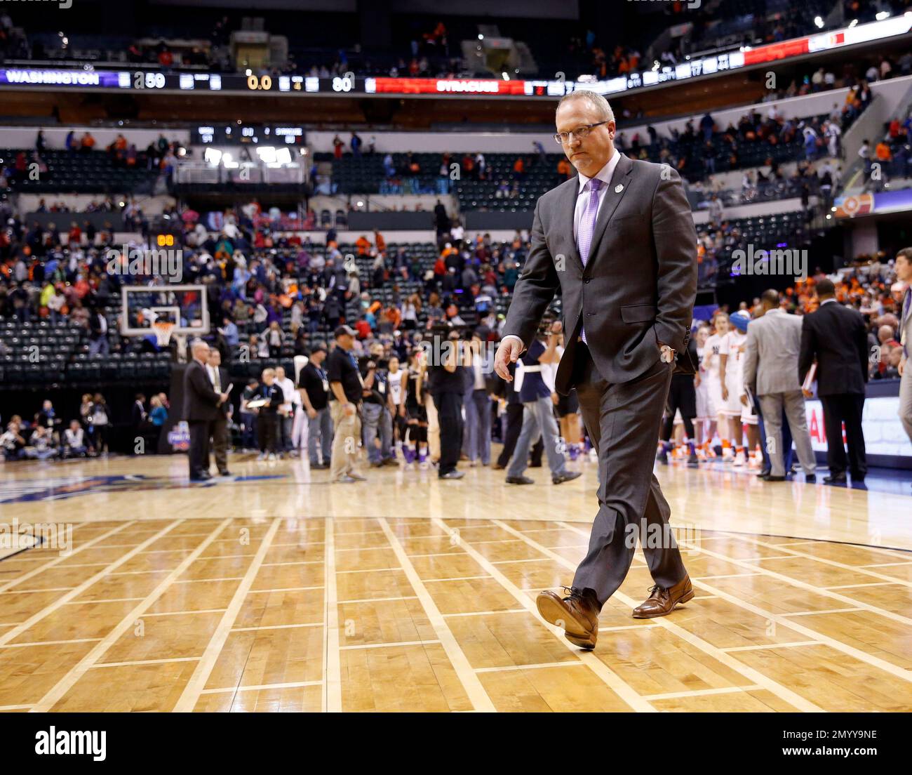 Washington head coach Mike Neighbors walks off the court following a ...