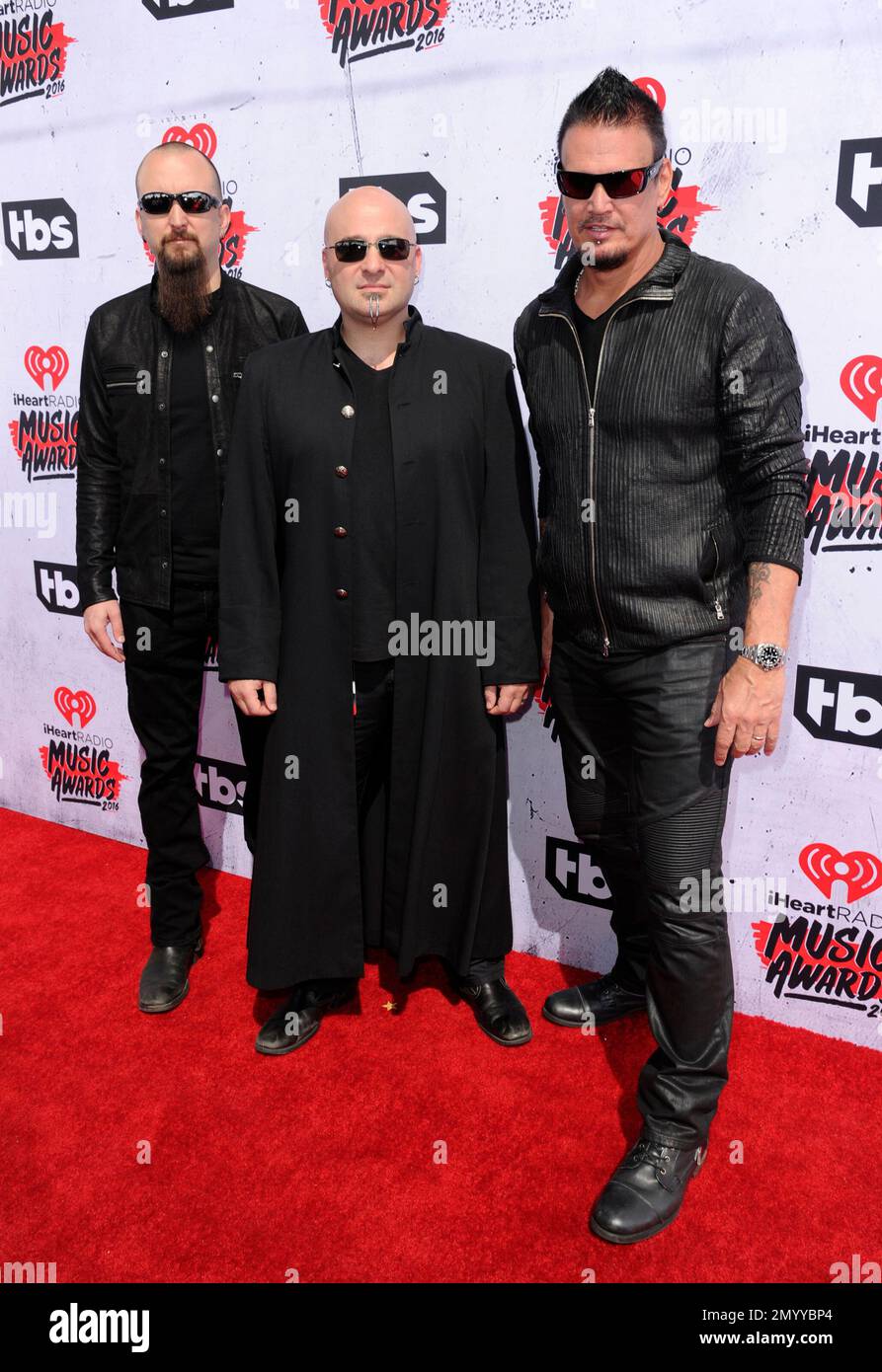 Mike Wengren, from left, David Draiman, and Dan Donegan of Disturbed arrive at the iHeartRadio ...