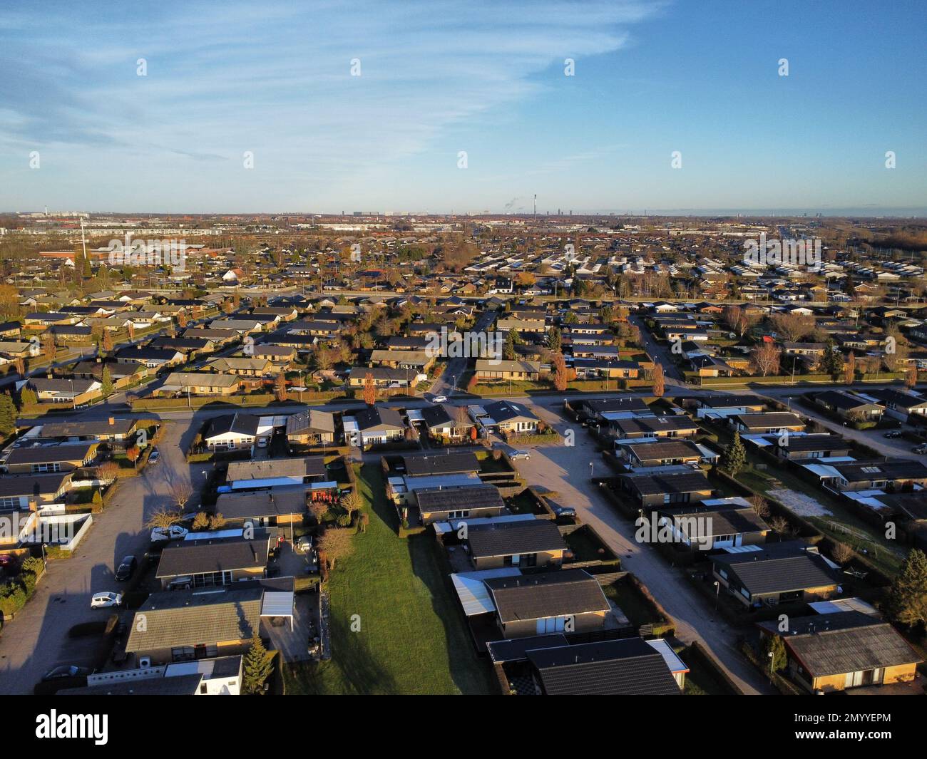 An aerial view of rural houses lines on meadows with forest trees in ...