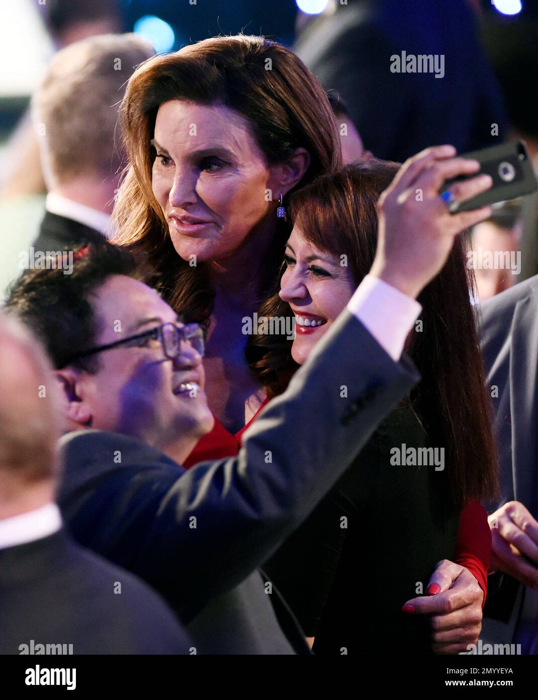 Caitlyn Jenner, top, poses for photos with audience members during the ...