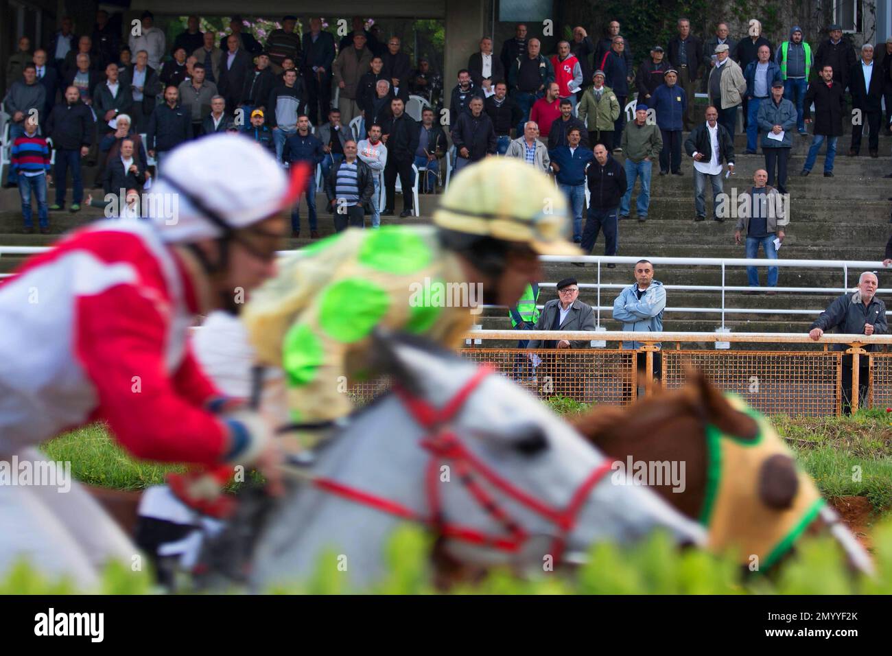 In this Thursday, March 24, 2016 photo, spectators watch a horse race ...