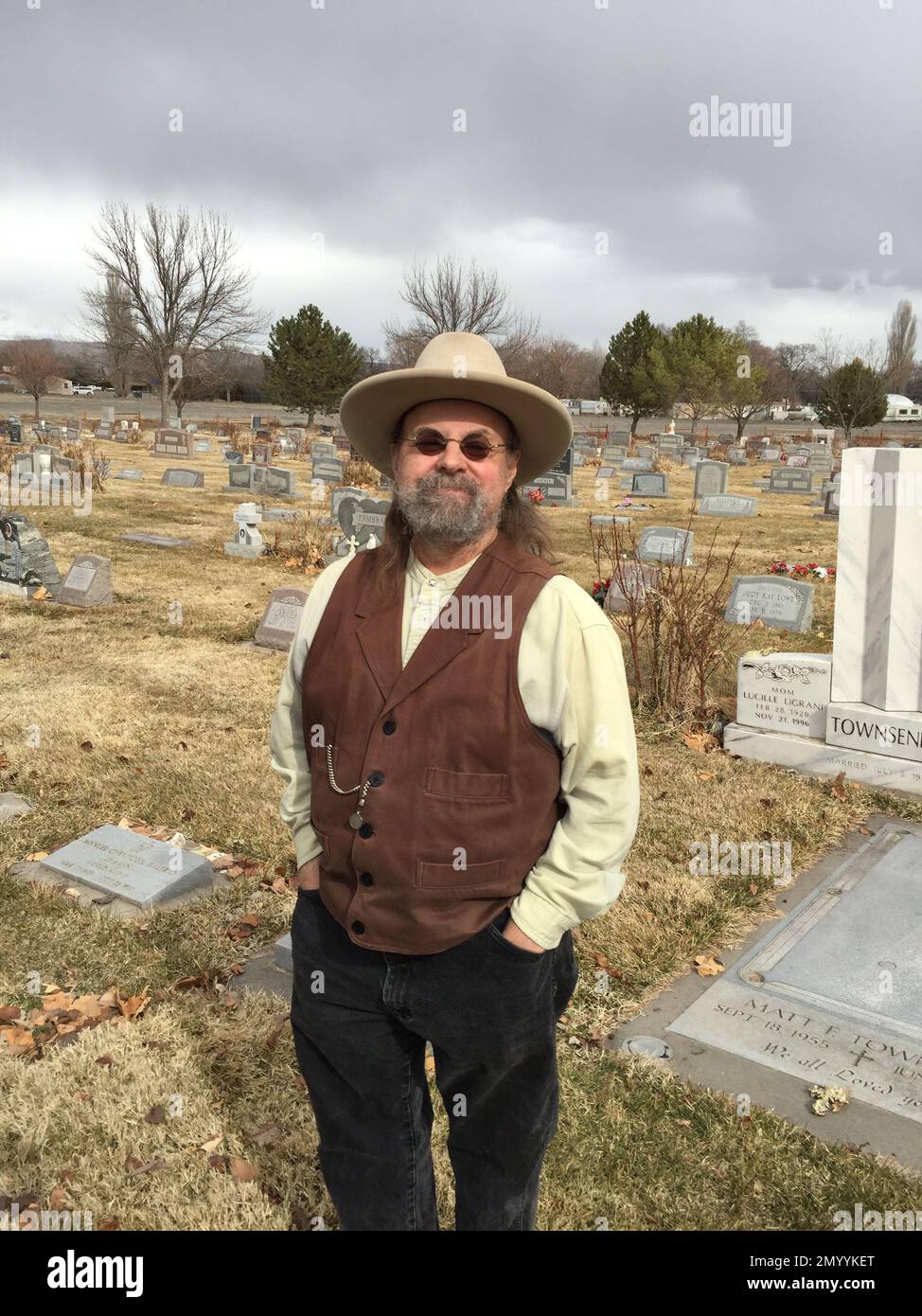 Dave Fishell, a local historian and gun collector, stands in a cemetery ...
